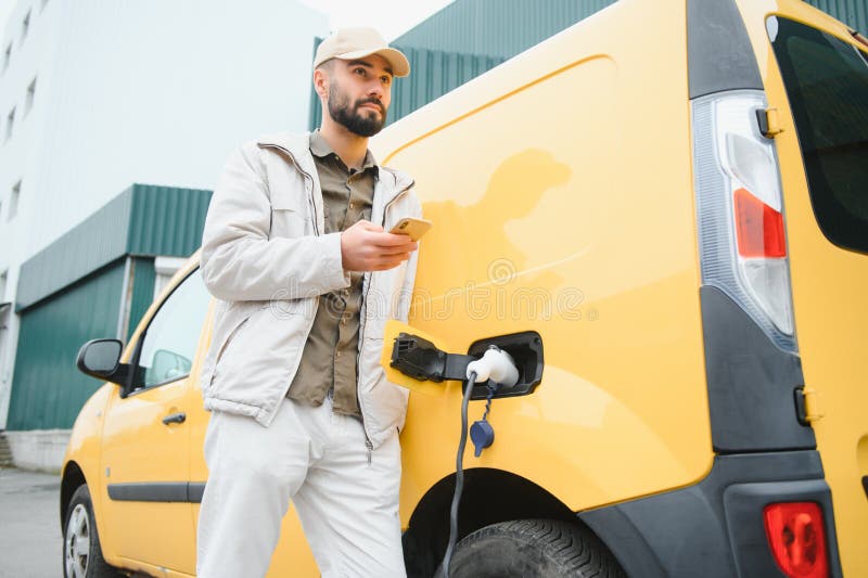 Man Charging Electric Car by the Work Stock Image - Image of modern ...