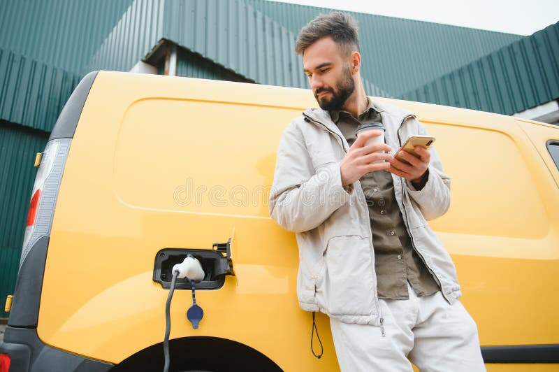 Man Charging Electric Car by the Work Stock Photo - Image of hybrid ...