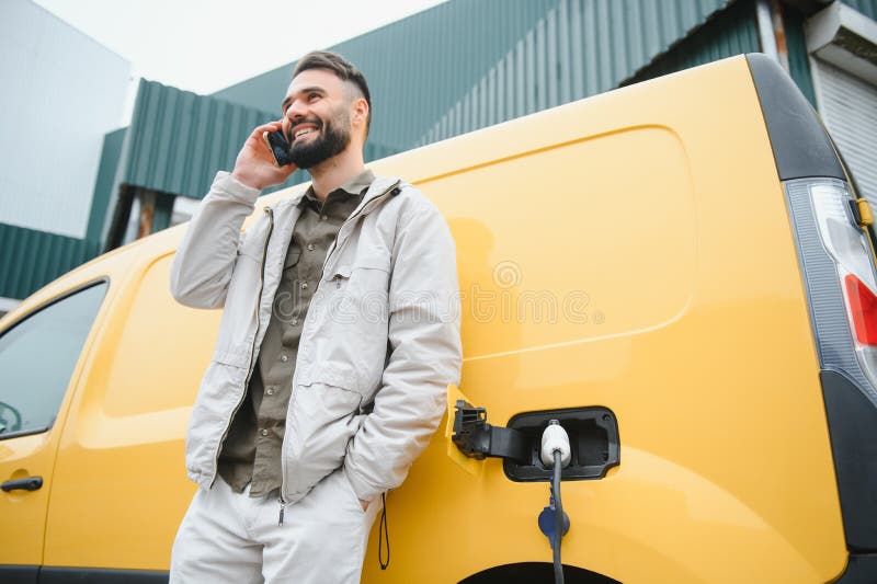 Man Charging Electric Car by the Work Stock Photo - Image of vehicle ...