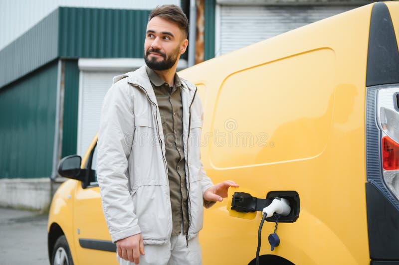 Man Charging Electric Car by the Work Stock Image - Image of charger ...