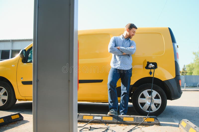 Man Charging Electric Vehicle with Cable Stock Image - Image of plug ...