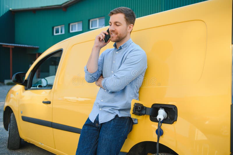 Man Charging Electric Vehicle with Cable Stock Photo - Image of cable ...
