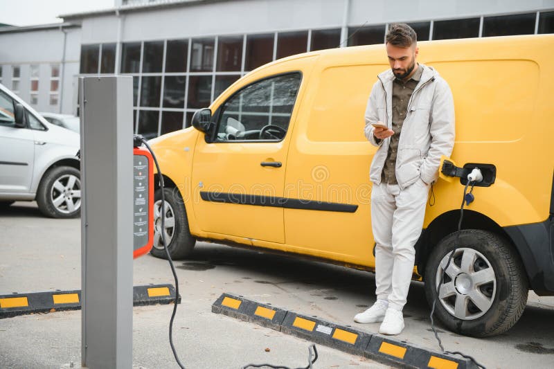 Man Charging His Electric Car. Stock Image - Image of technology, green ...