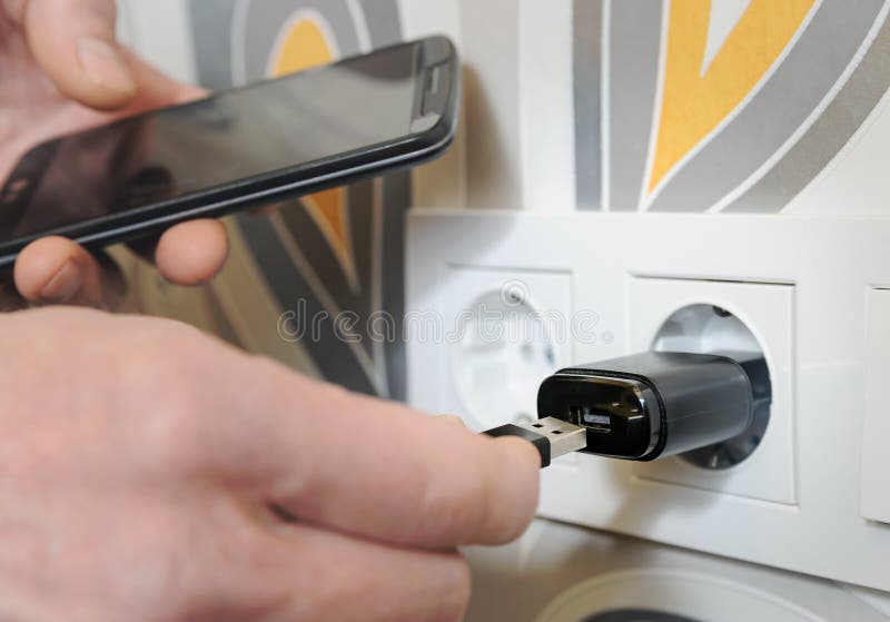 A Man is Charging the Smartphon. Stock Photo - Image of home, charging ...