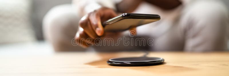 Man Charging Smartphone Using Wireless Charging Pad Stock Image - Image ...