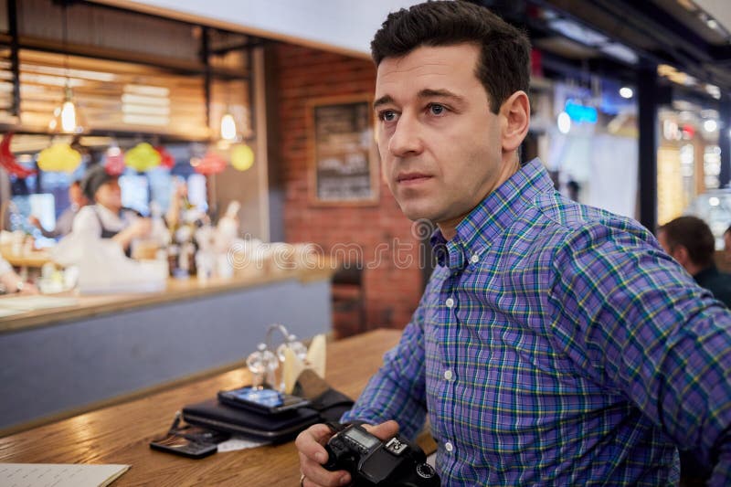 Man in Checkered Shirt with Camera in Hand Stands Stock Image - Image ...