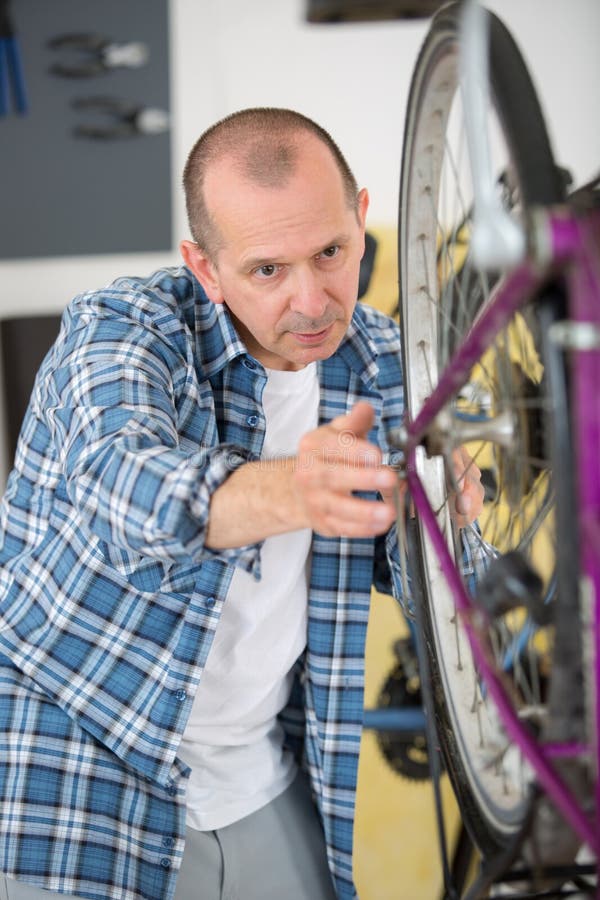 Man Checking Bicycle Wheel Alignment Stock Photo - Image of axle ...