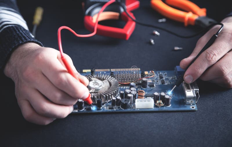 Man Checking Computer Motherboard with a Multimeter Stock Photo - Image ...