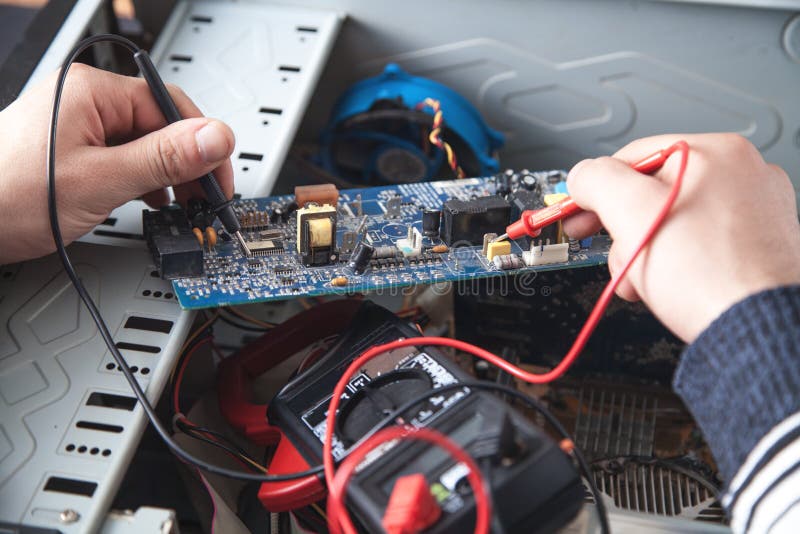 Man Checking Computer with a Multimeter Stock Photo - Image of repair ...