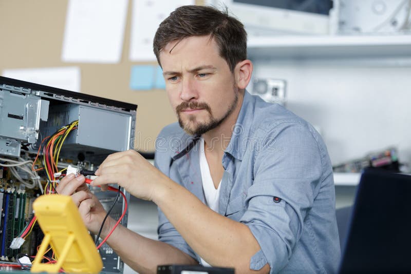 Man Checking Computer with Multimeter Stock Photo - Image of technology ...