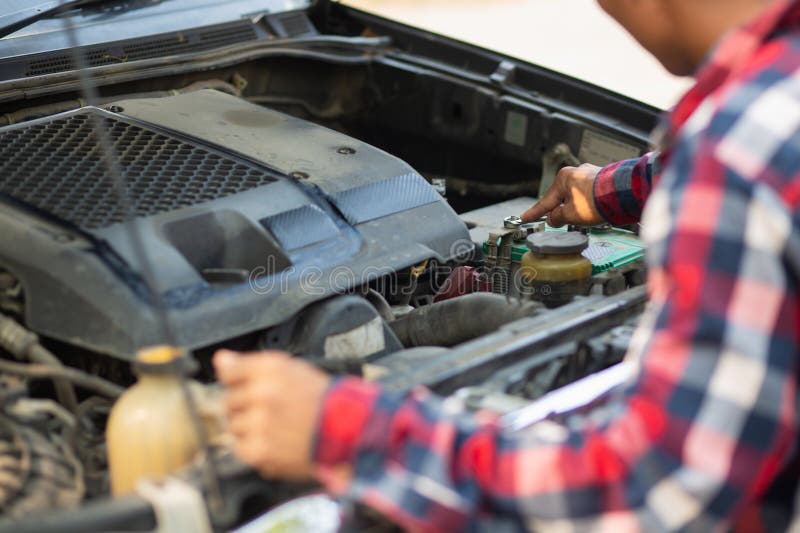 The Man is Checking the Engine and Condition of Car To Fix it Properly ...
