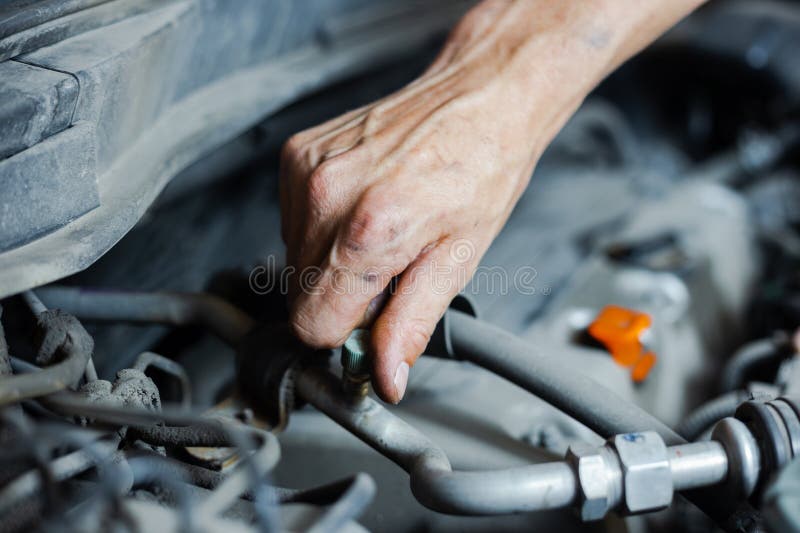 A Man is Checking the Engine Oil on a Car for a Replacement. Stock ...
