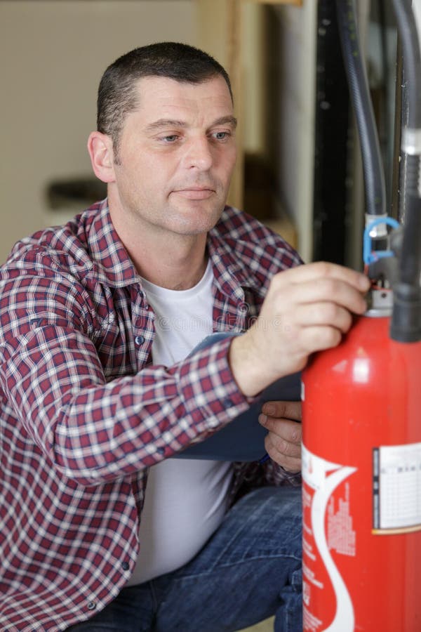 Man Checking Fire Extinguisher Writing Document Stock Photos - Free ...