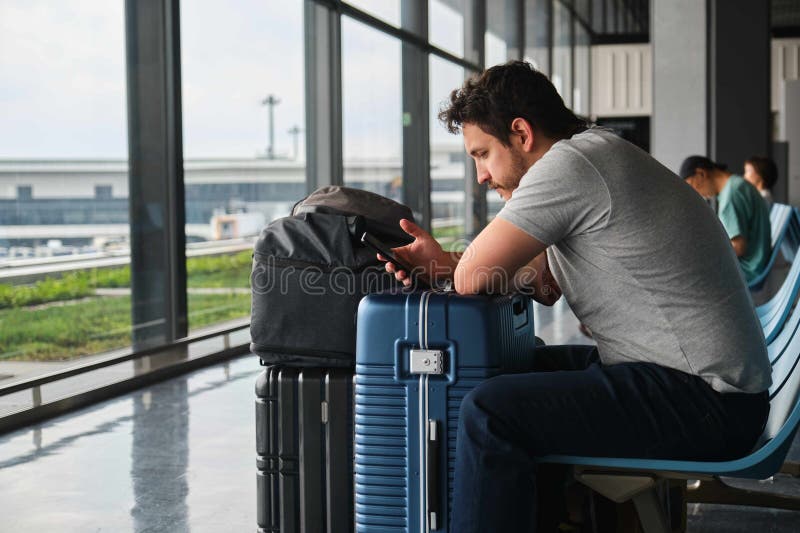 Man Checking the Flight Information on His Smartphone at the Airport ...