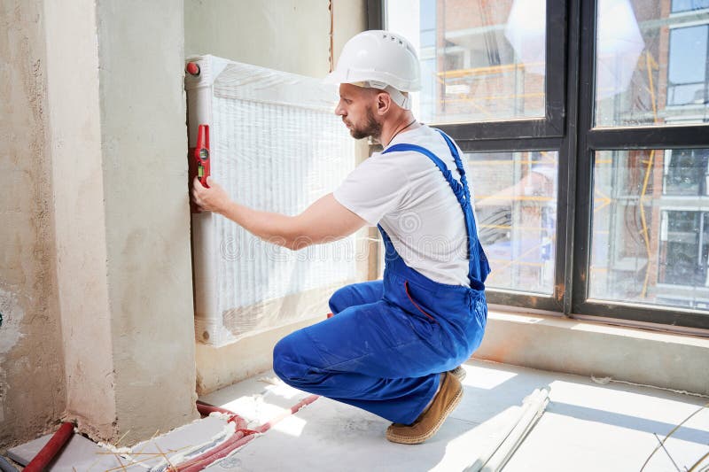 Man Checking Heating Radiator with Spirit Level Tool at Home. Stock ...