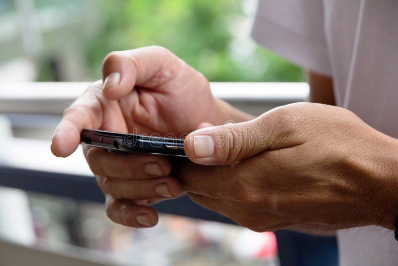 Man checking his phone stock image. Image of adult, outdoor - 33789017
