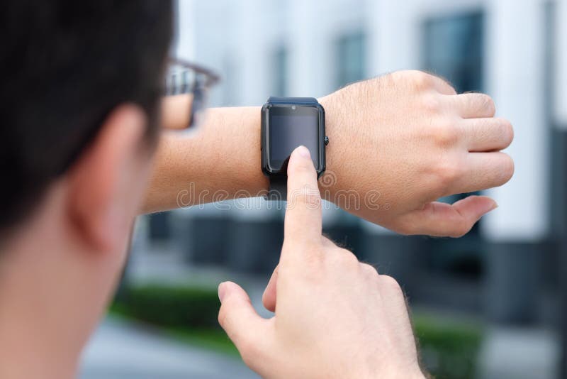 Man Checking His Smartwatch Outdoors. High Angle Shot Stock Image ...
