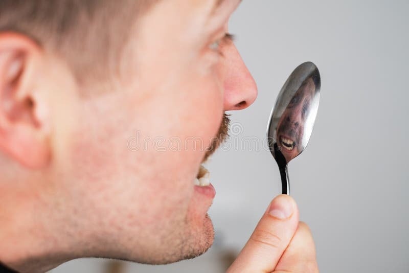 Man Checking His Teeth after Meal Looking on His Reflection in Spoon ...