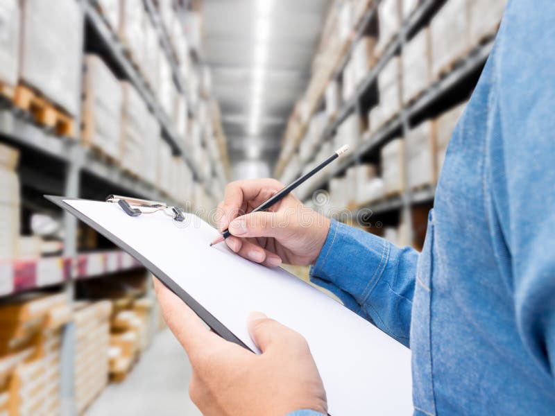 Man Checking List on Clipboard in a Warehouse Stock Photo - Image of ...
