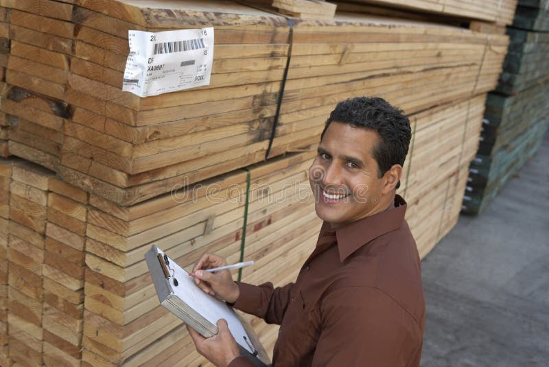 Man Checking Lumber in Warehouse Stock Photo - Image of business ...
