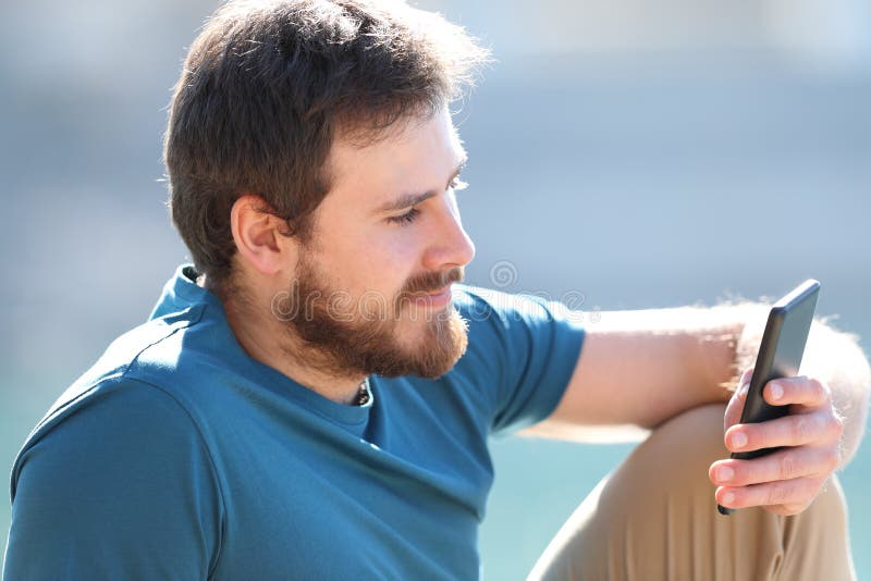 Happy Man Checking Phone Under an Umbrella in Winter Stock Image ...