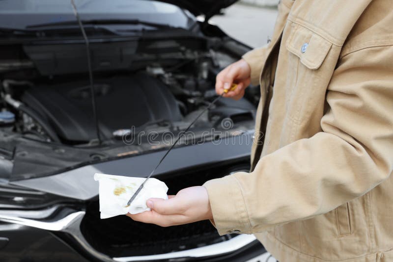 Man Checking Motor Oil Level in Car with Dipstick, Closeup Stock Photo ...