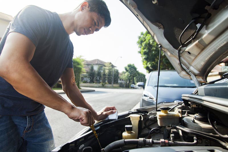 Man Checking Motor Oil Level in Car with Dipstick, Closeup Stock Photo ...