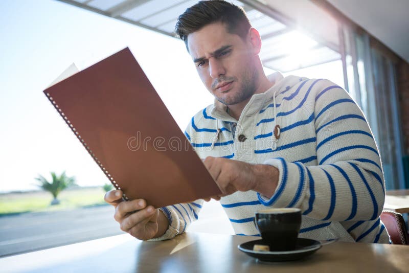Man checking out the menu stock photo. Image of holding - 76025150