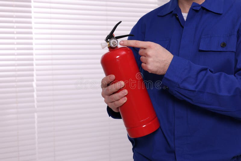 Man Checking Pressure and Quality of Fire Extinguisher Indoors, Closeup ...