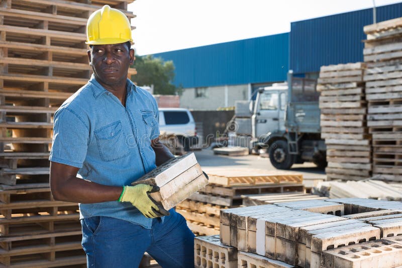 Man is Checking Quality of Bricks in the Open Area of a Construction ...