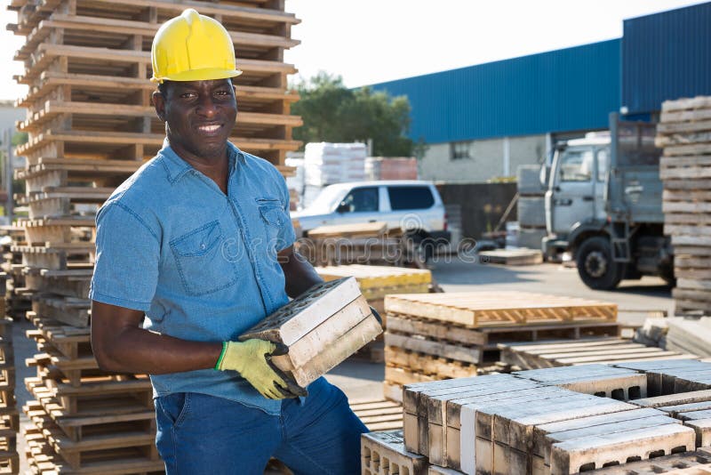 Man is Checking Quality of Bricks in the Open Area of a Construction ...