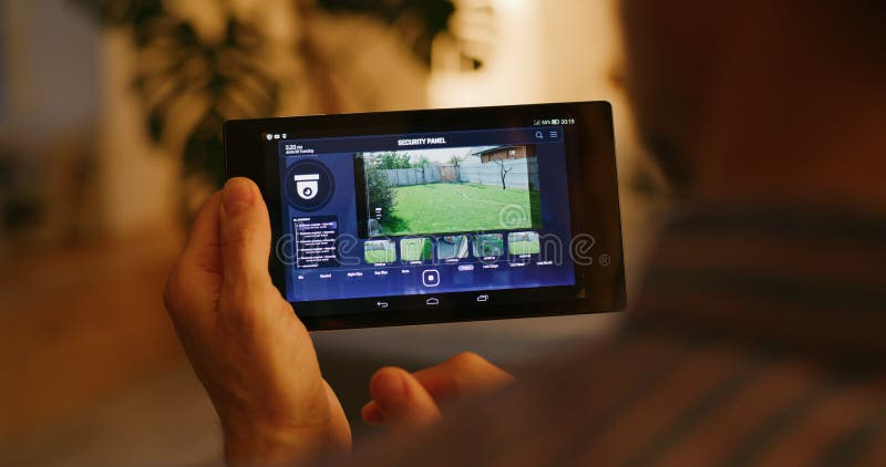 Man Checking Security Camera through Home Hub Stock Photo - Image of ...