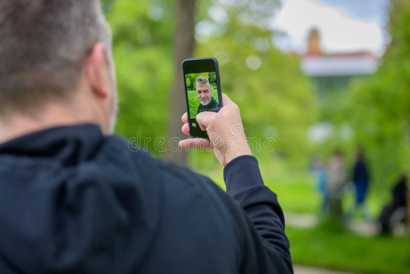 Man Checking a Selfie Image on the Screen of His Mobile Stock Photo ...