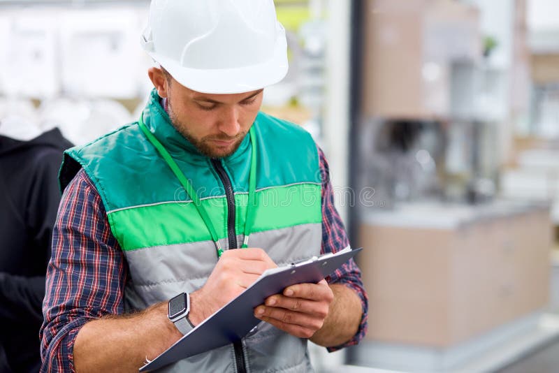 Man is Checking Supplies on Document with an Engrossed Expression in ...