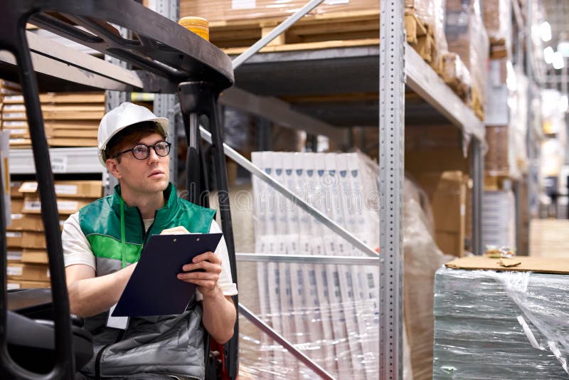 Man is Checking Supplies on Document with an Engrossed Expression in ...