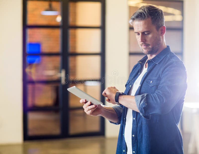 Man Checking Time while Holding Tablet in Office Stock Photo - Image of ...