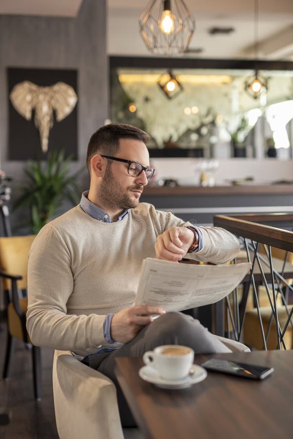 Man Checking the Time while Reading Newspapers Stock Image - Image of ...