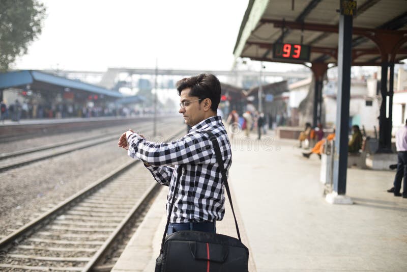 Man Checking Time while Waiting at Railway Station Stock Photo - Image ...