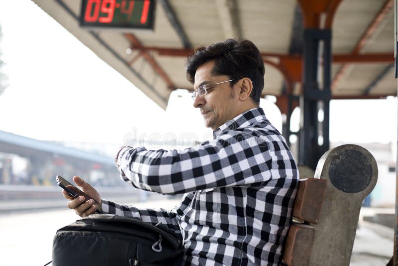 Man Checking Time while Waiting at Railway Station Stock Photo - Image ...