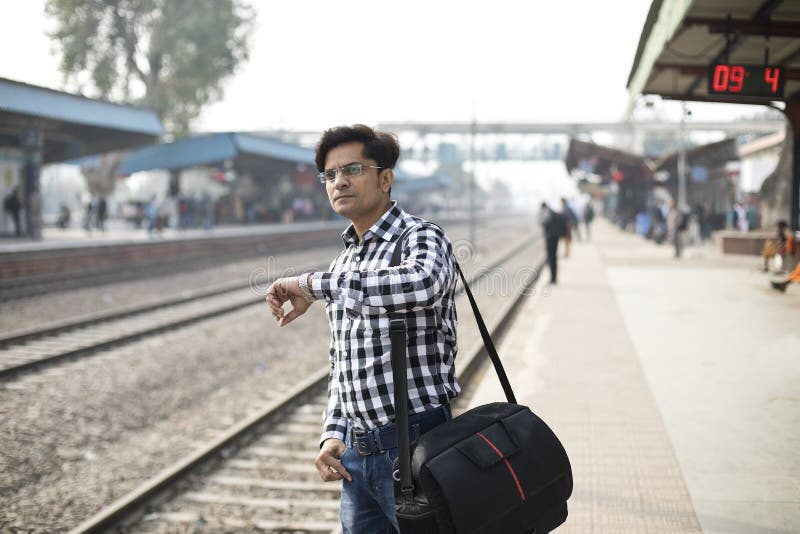 Man Checking Time while Waiting at Railway Station Stock Image - Image ...