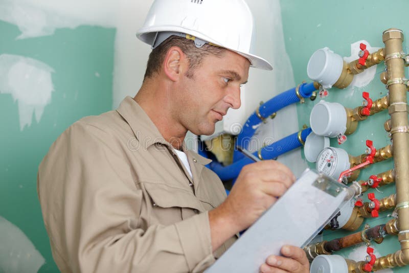 Man checking water meter stock photo. Image of engineer - 150568770