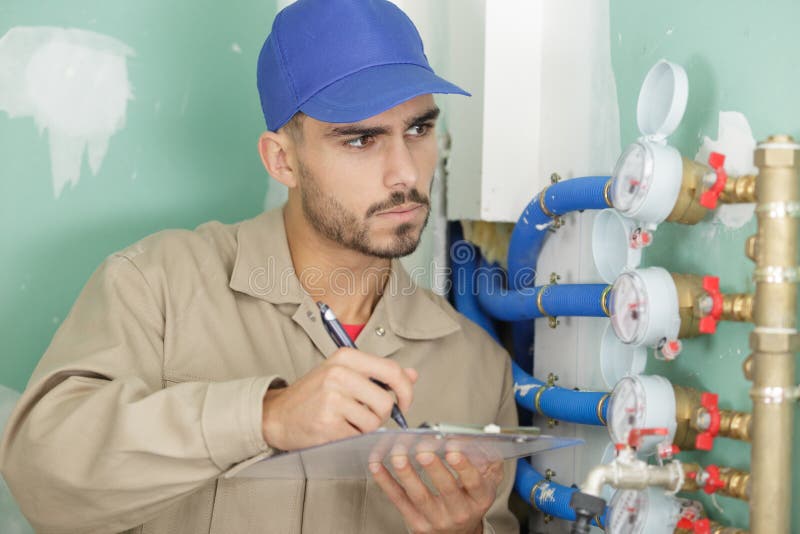 Man checking water meter stock image. Image of view - 227973257