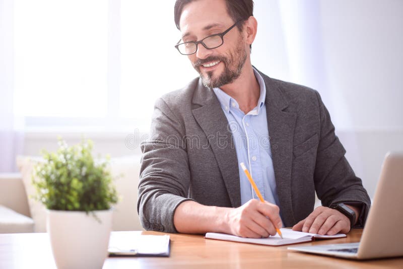 Man Checking while Writing in the Notebook Stock Image - Image of ...