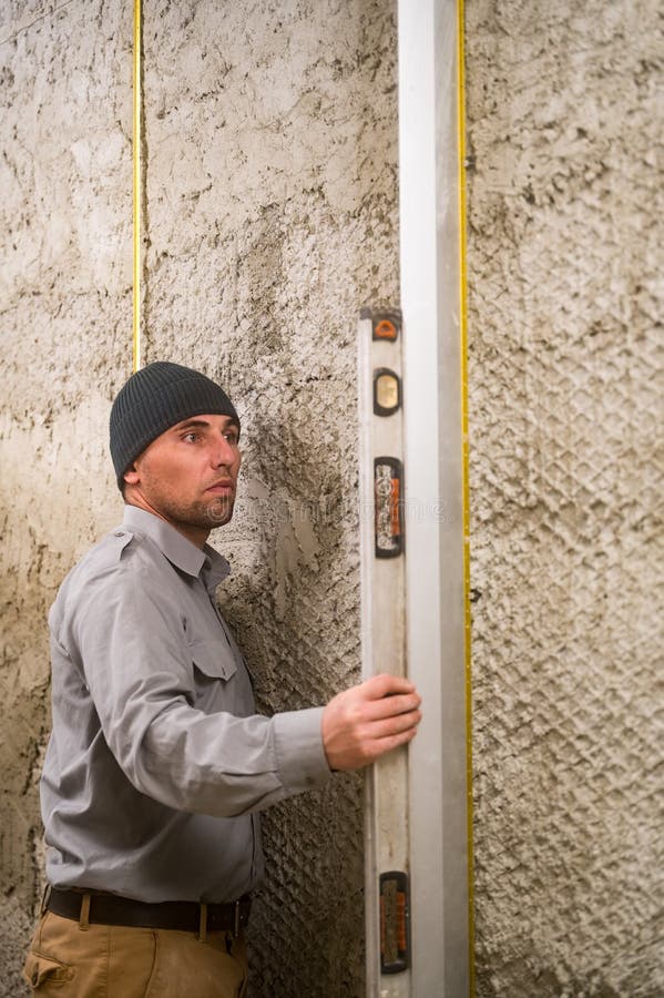 A Man Checks the Attached Guide Beacon for Equality with a Level ...