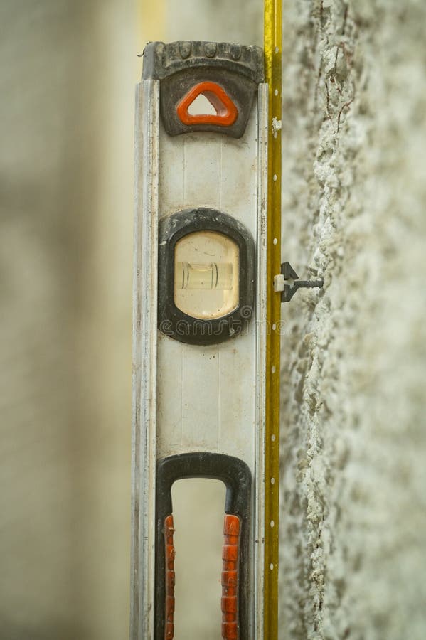 A Man Checks the Attached Guide Beacon for Equality with a Level ...