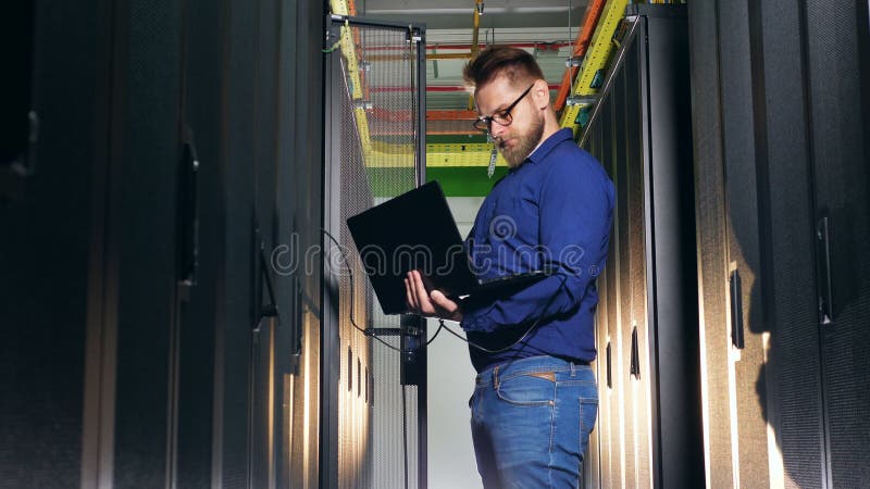Server Room with a Robot Being Set by an Engineer with a Computer Stock ...