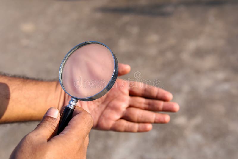 Man Checks Hand with Magnifying Glass Stock Image - Image of ...