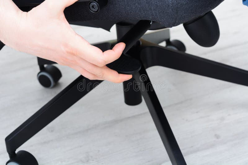 Man Checks Lifting Mechanism of Chair. Assembling Office Chair Indoors ...