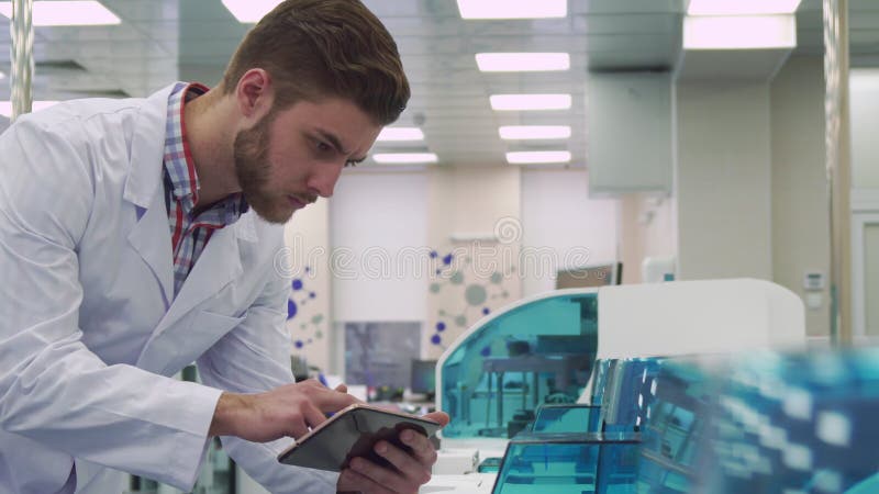 Man Checks the Work of Lab Device with Tablet Stock Image - Image of ...
