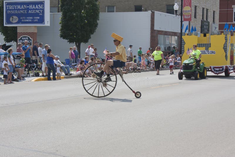 Man with Cheesehead Riding High Wheel Bicycle in Parade Editorial Photo ...